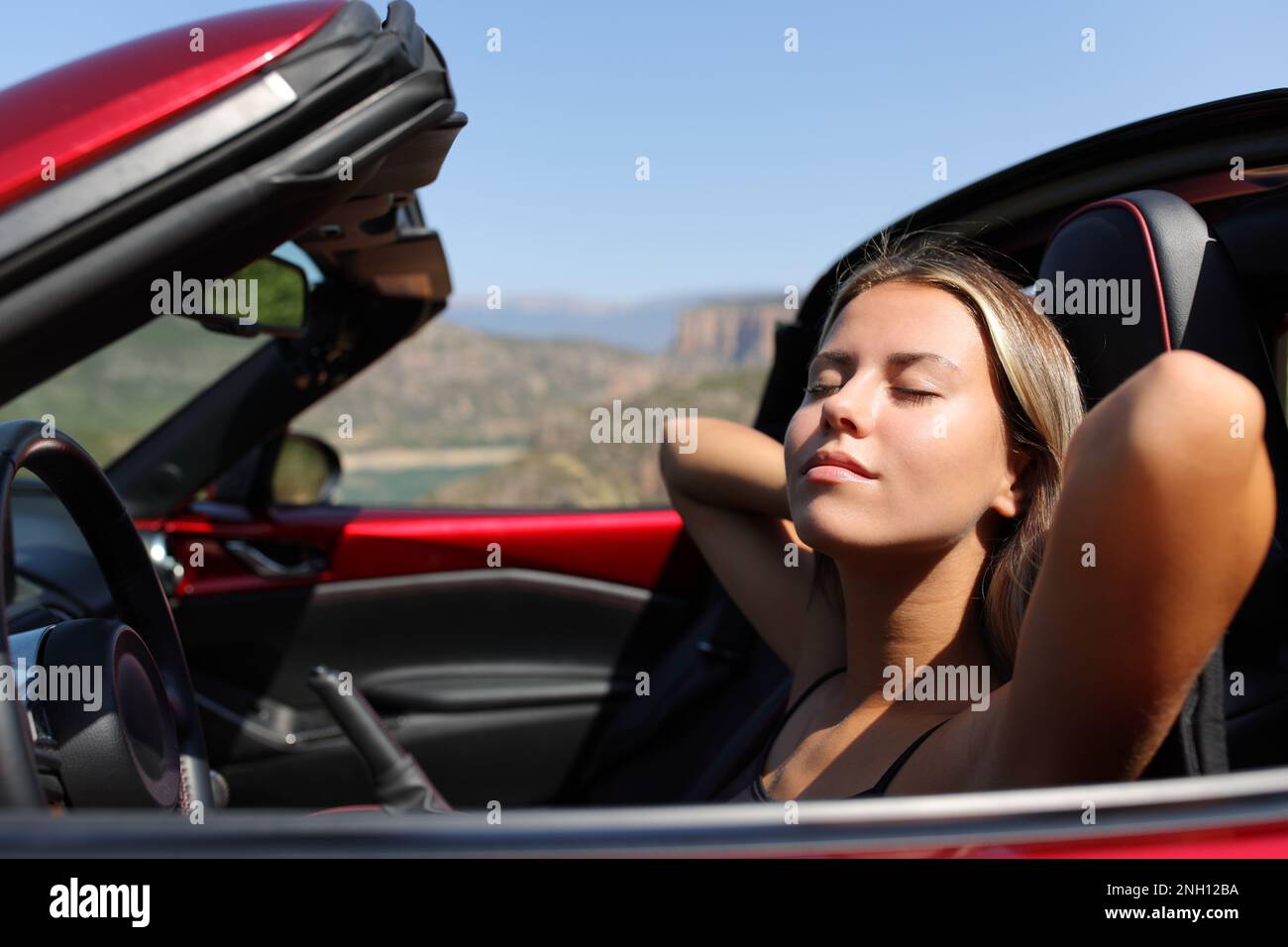 Convertible car driver resting a sunny day in the mountain Stock Photo ...
