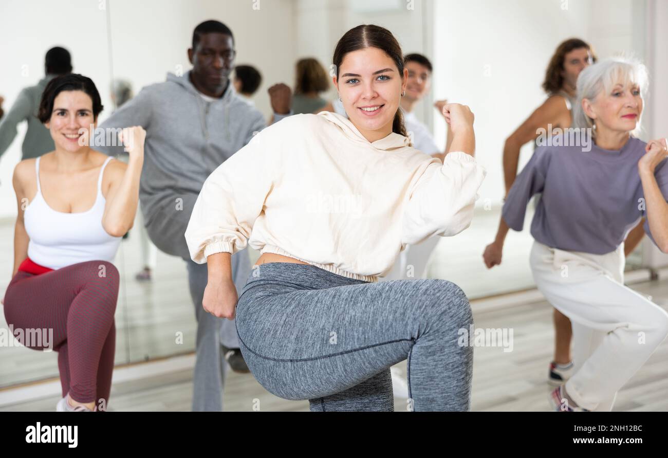 Young girl practicing vigorous dance movements in group class Stock ...