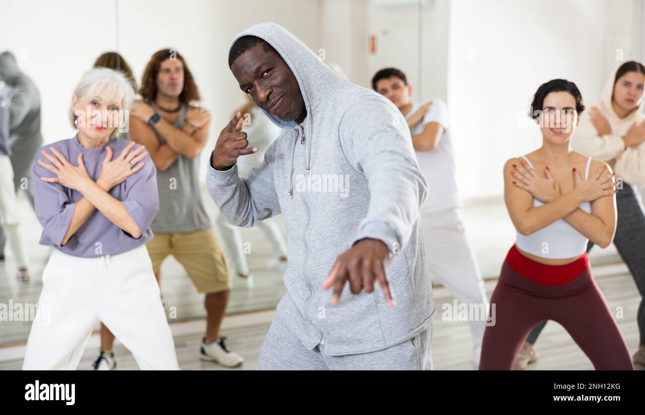 Group of multinational people practicing new modern dance techniques ...