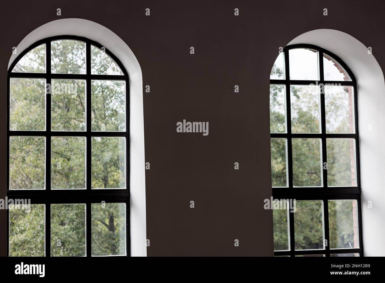 Large arched windows looking out into a garden. old windows of house ...