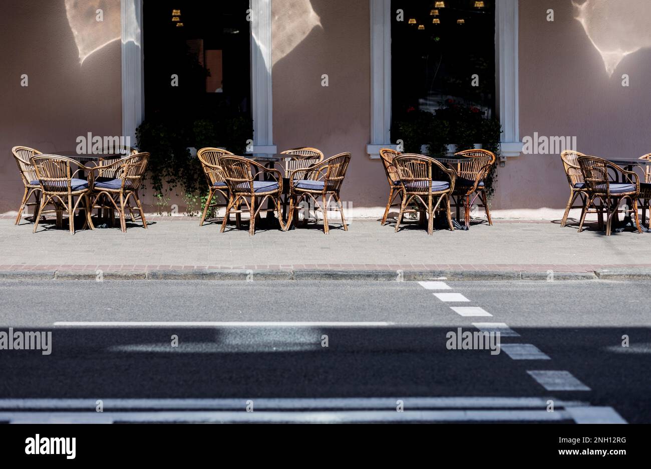 romantic street restaurant with tables and chairs on a sunny day ...