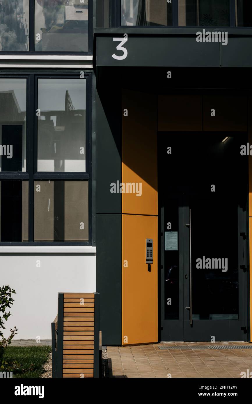 Outside solid glass door with building exterior Stock Photo - Alamy