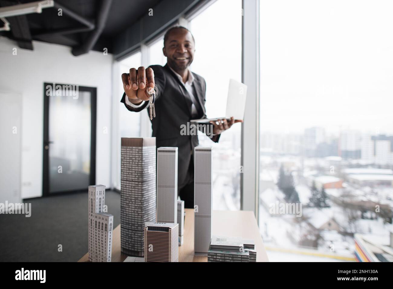 Focus on keys in hand of african real estate manager homeowner ...