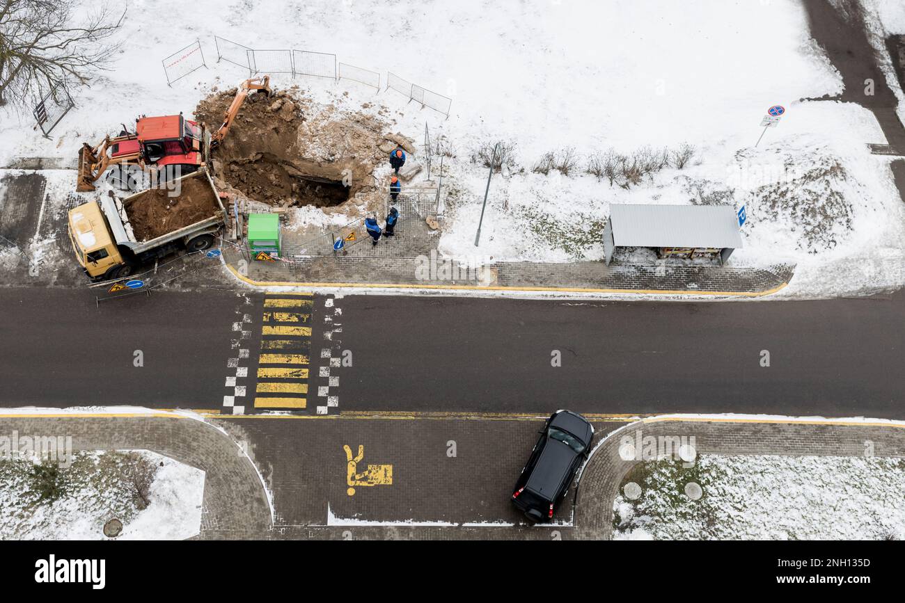 Crawler excavator and workers in construction site. view from the ...
