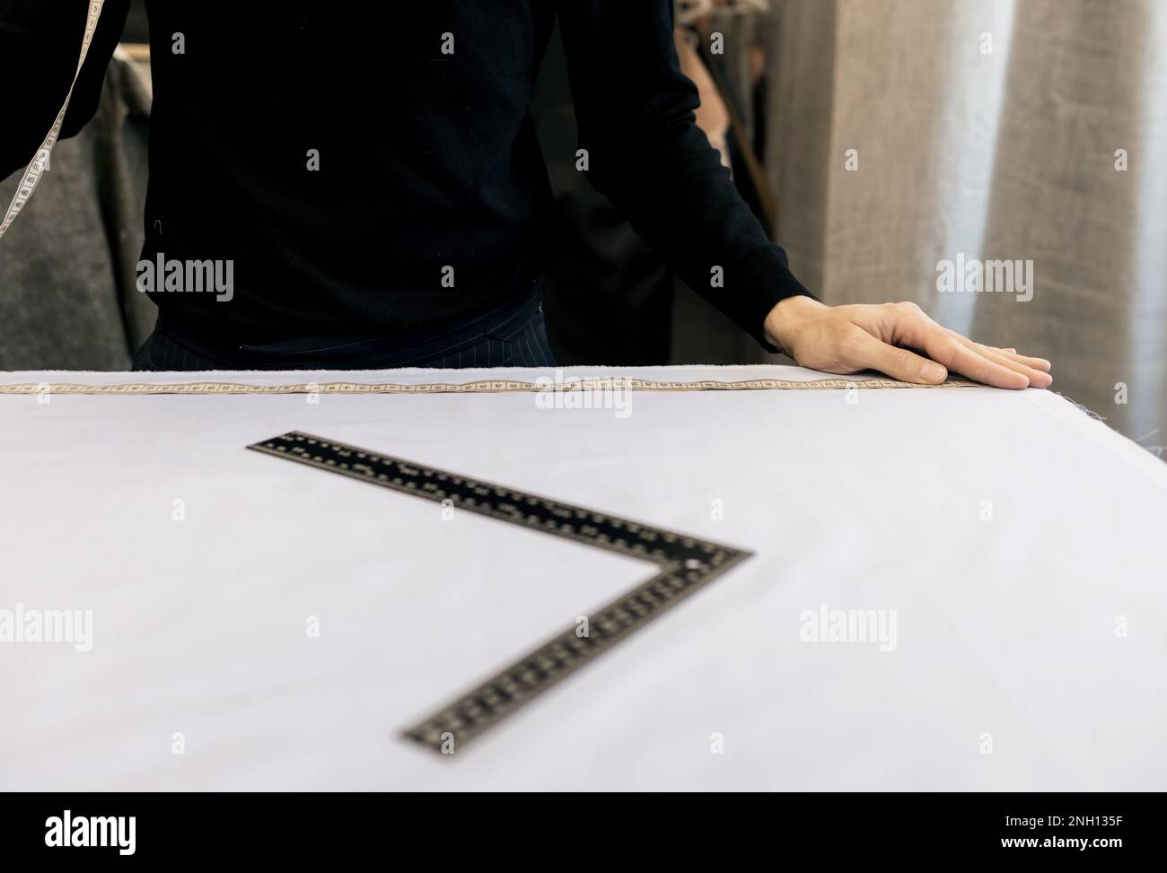 Tailor at work. Dressmaker making clothes in modern studio. Tailor ...