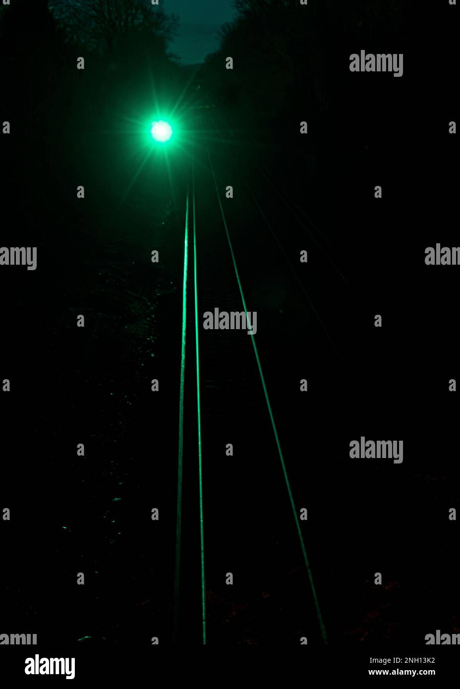 Green light on a nighttime railway line Stock Photo - Alamy