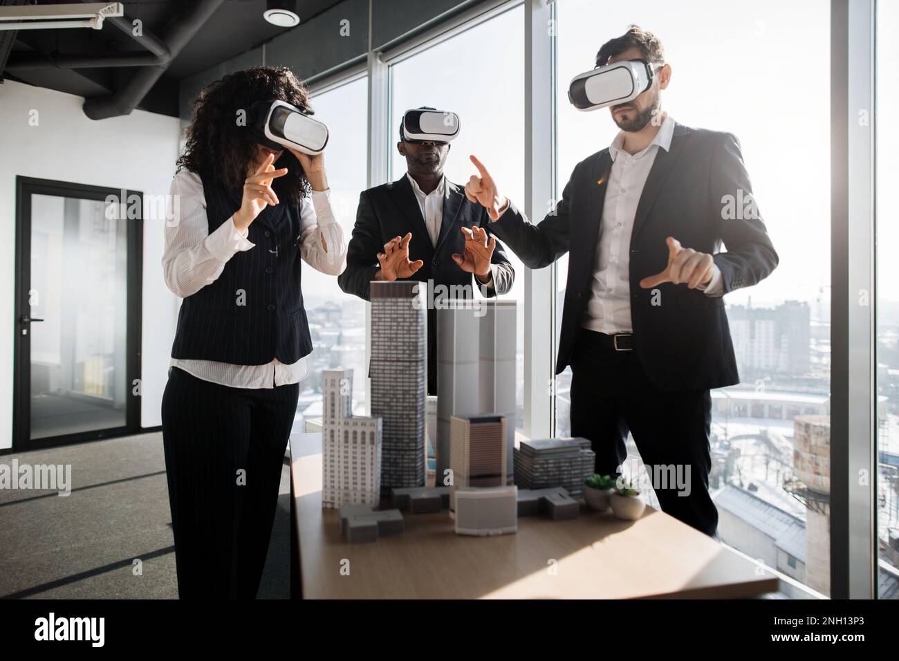 Multiethnic creative business team using virtual reality headsets at the meeting in modern ...