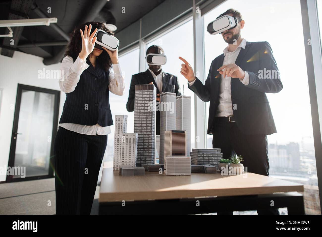 Focused three multiethnic professional business colleagues in formal ...