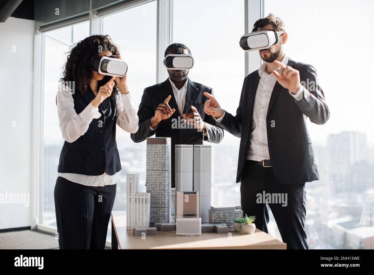 Multiracial business people, using VR glasses, making team training ...