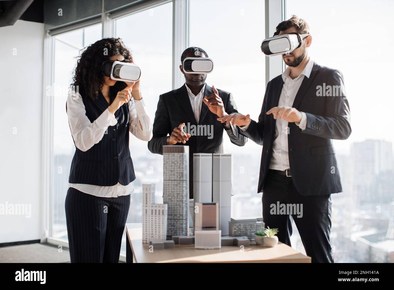 VR, business meeting conference. Multiethnic male and female business people wearing virtual ...