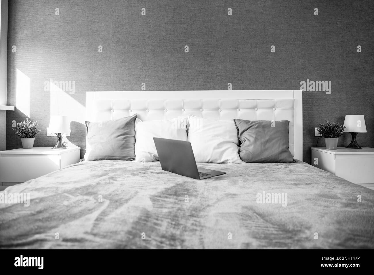 home workspace of laptop on bed in bedroom Stock Photo - Alamy