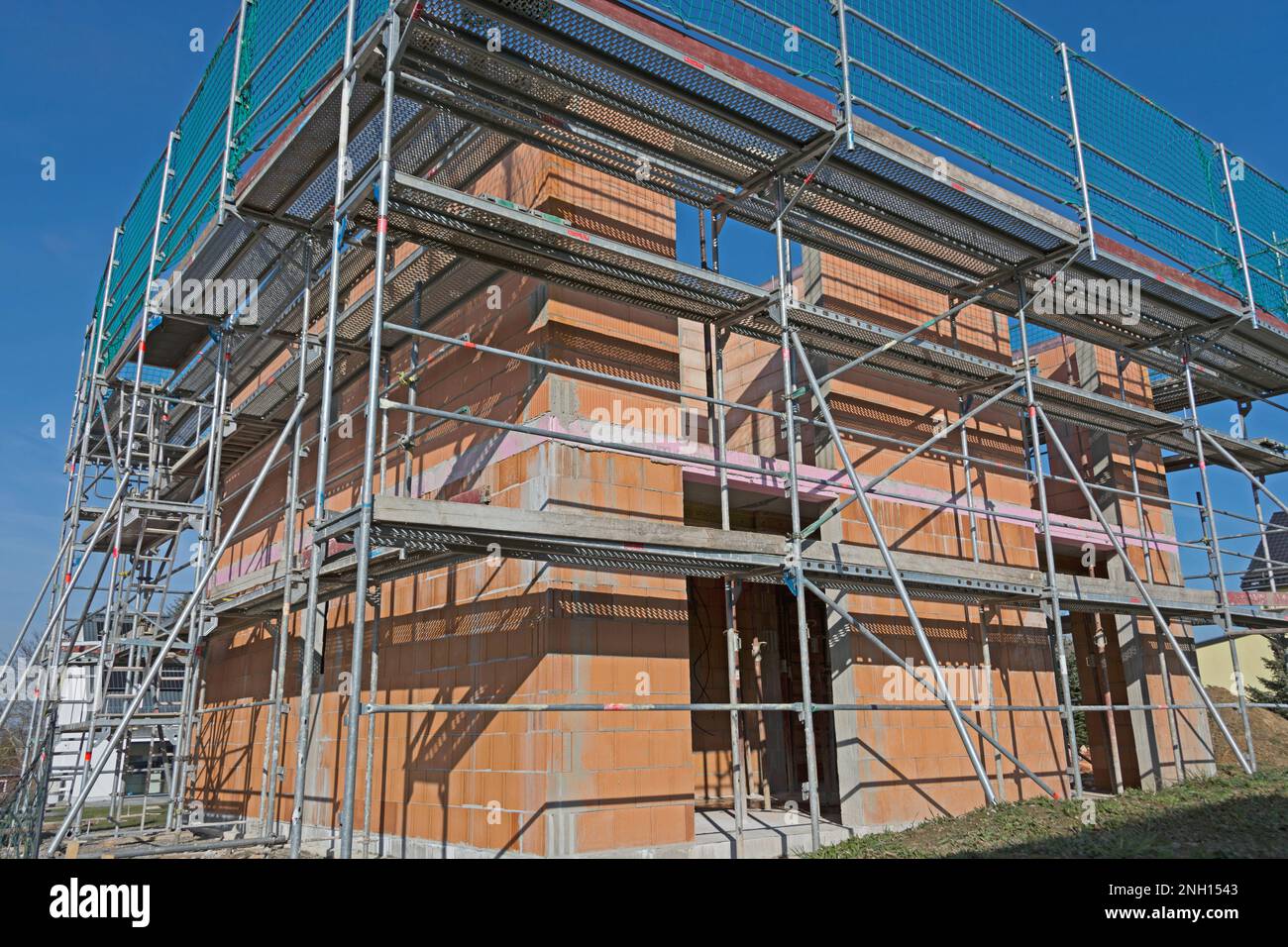 Massive home in shell construction with scaffolding Stock Photo - Alamy