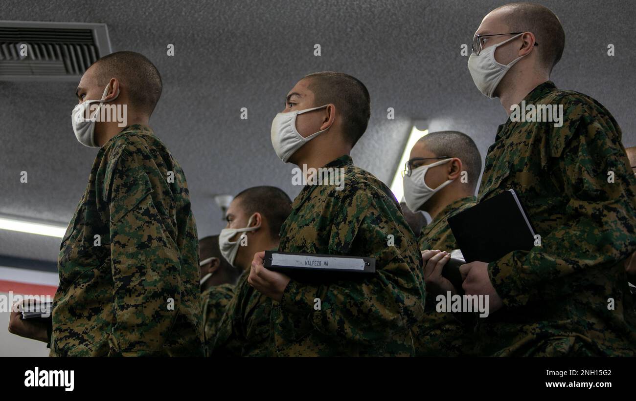 U.S. Marine Corps Recruits with Delta Company, 1st Recruit Training Battalion, wait in line to ...