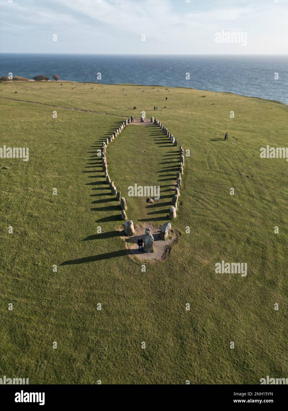 A diverse group of people standing in a circular formation, smiling ...