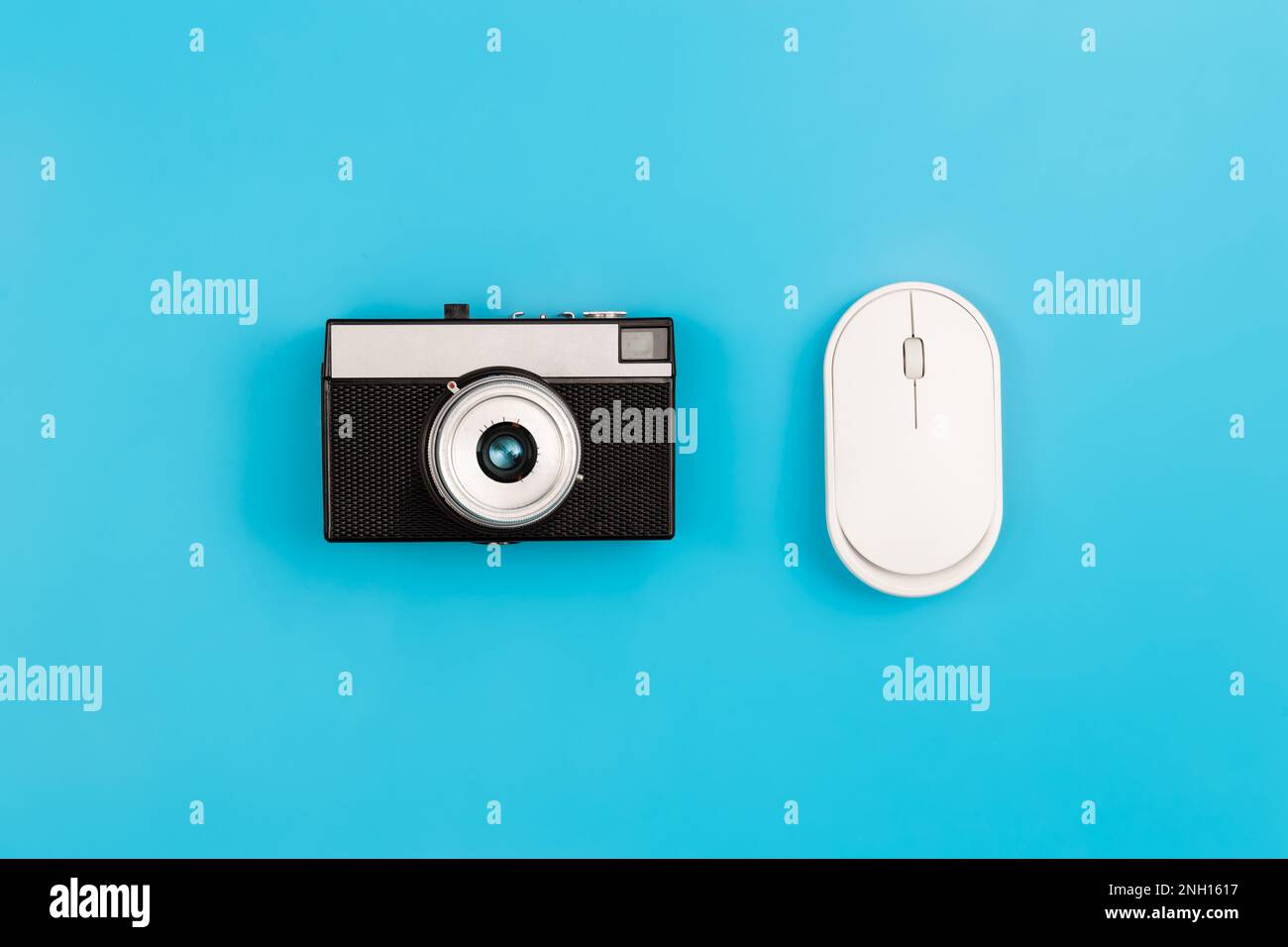 Vintage camera and computer mouse on a blue background isolated Stock ...