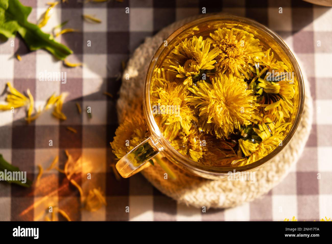 Dandelion flower healthy tea in glass cup on table. Herbal medicine ...