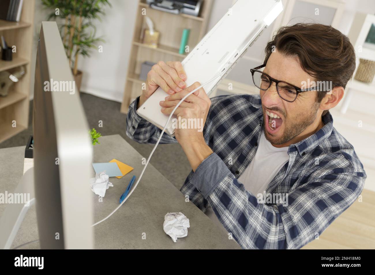 angry and upset man wants to break his pc Stock Photo - Alamy