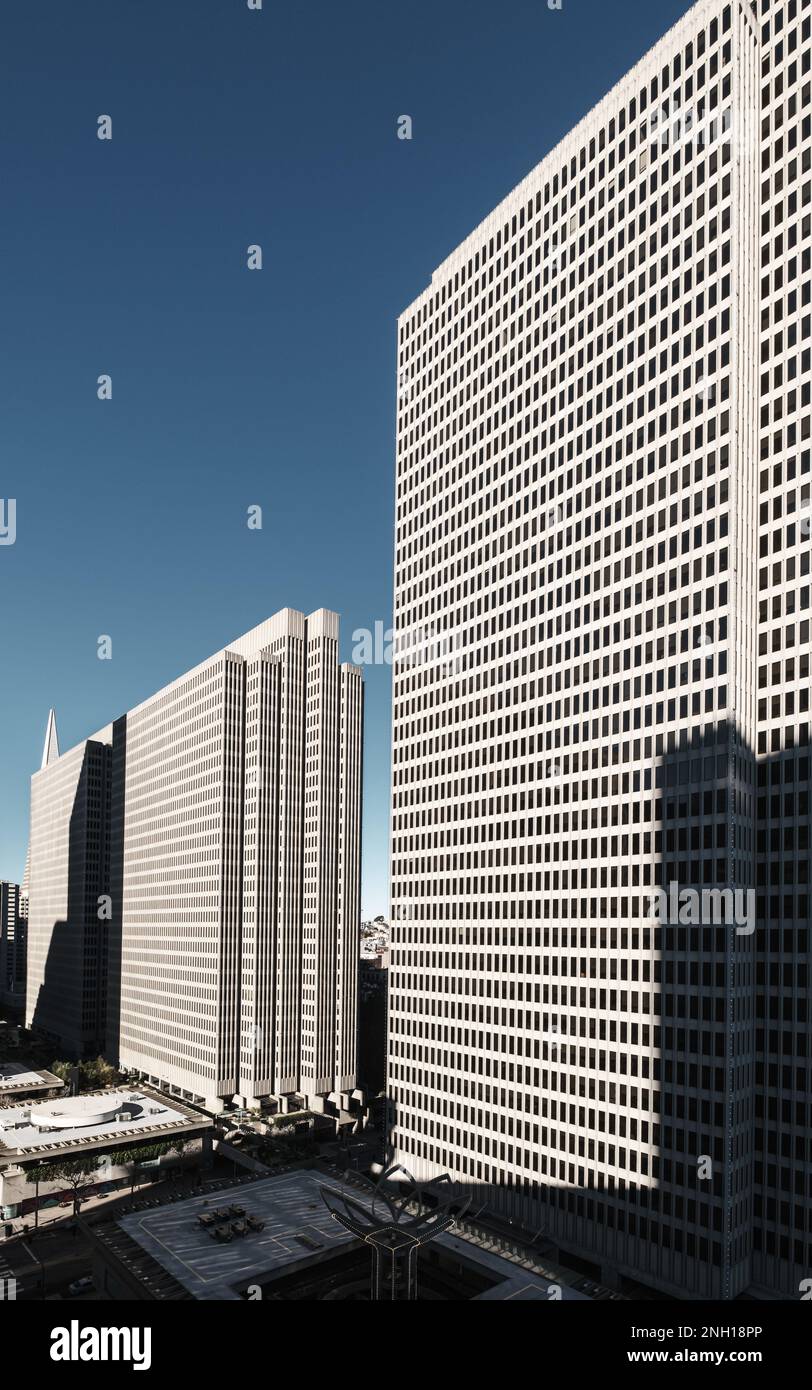 Monotone skyscrapers lit by morning sunshine stand out against a deep ...