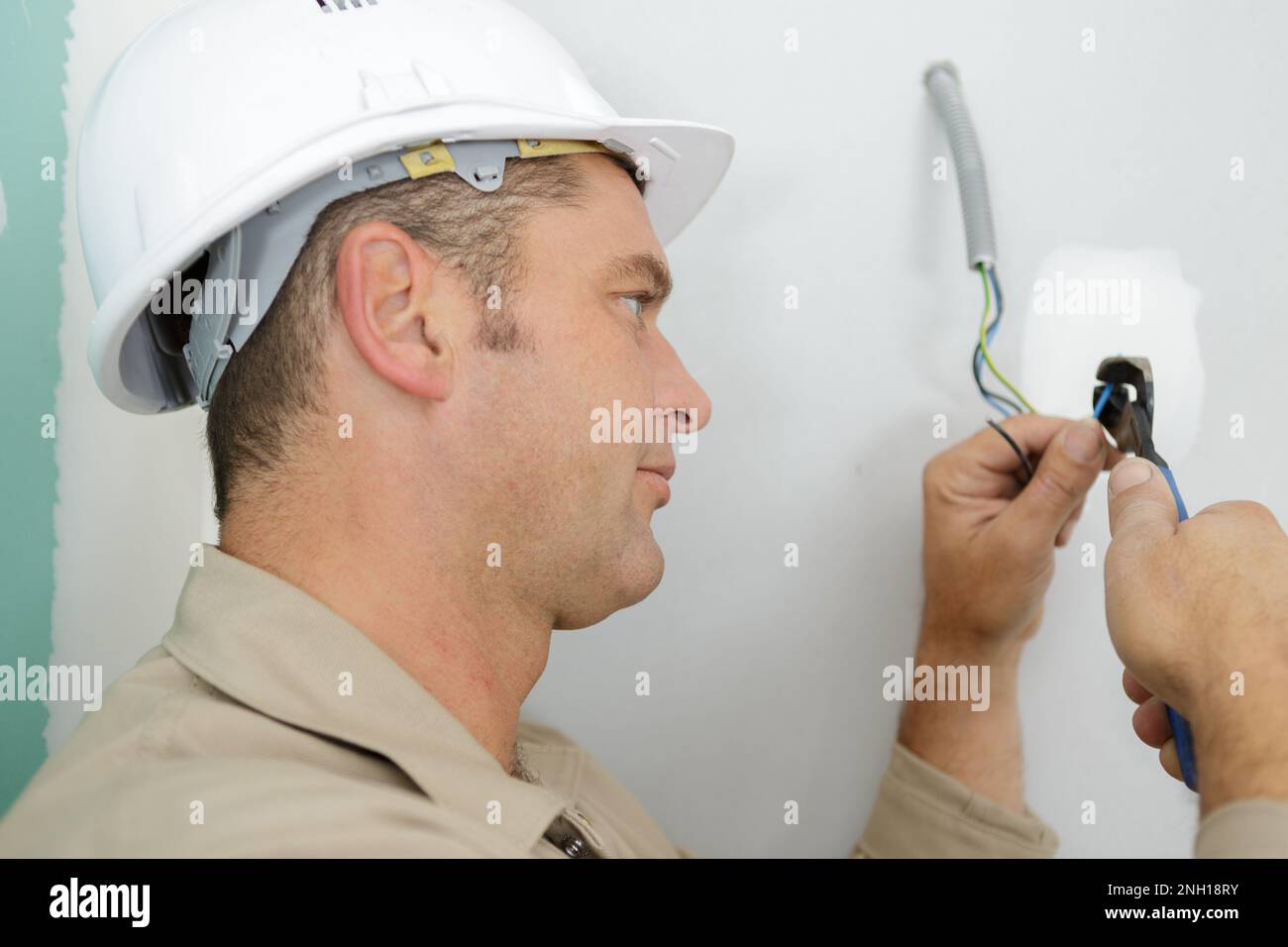 mature male electrician connecting cables Stock Photo - Alamy