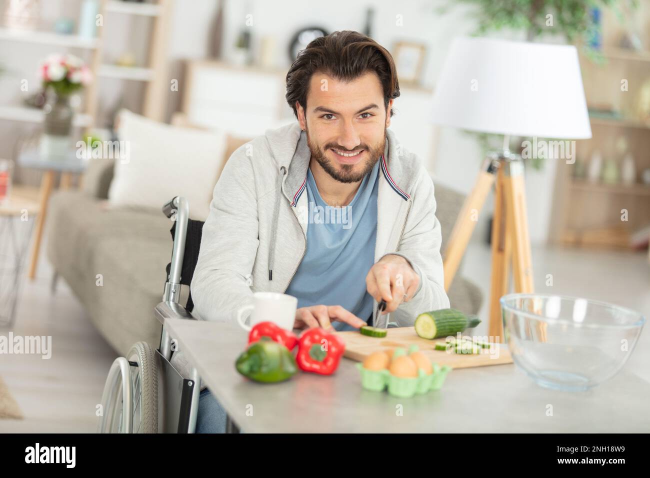 Disabled man in wheelchair chopping hi-res stock photography and images ...