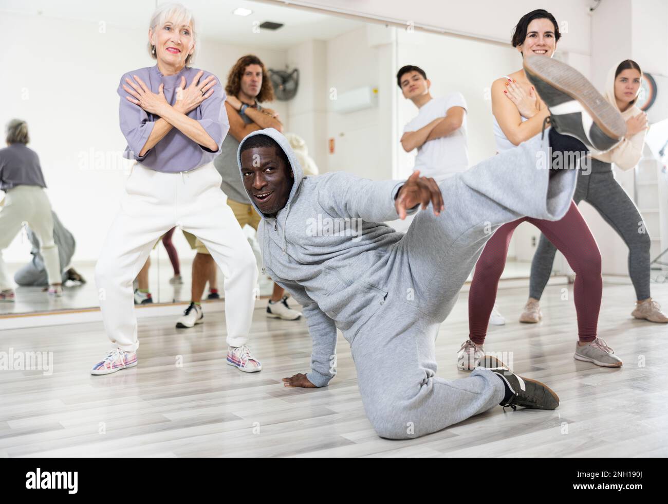 Group of multinational people practicing new modern dance techniques ...