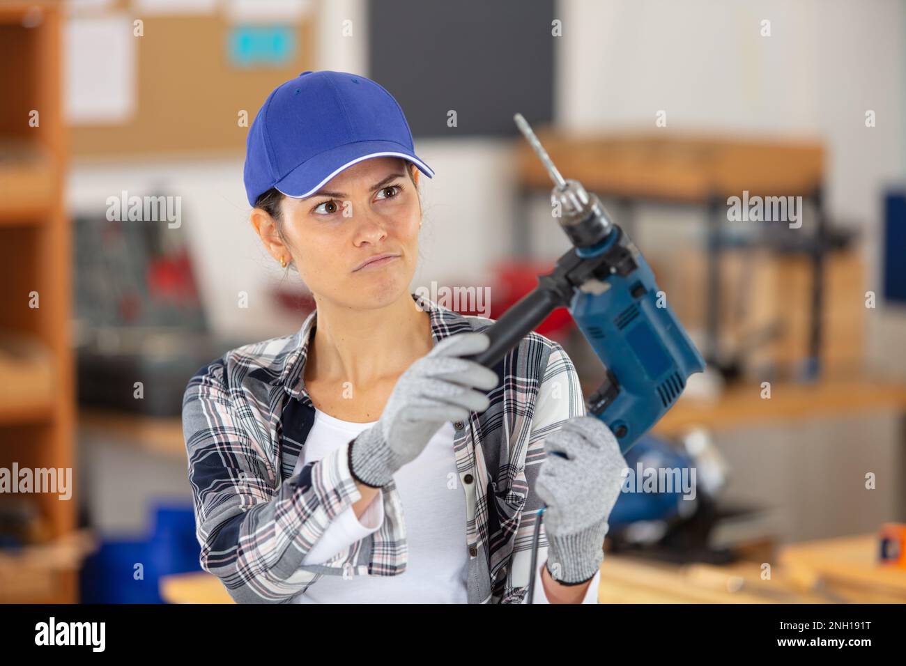 female carpenter using electric drill Stock Photo - Alamy
