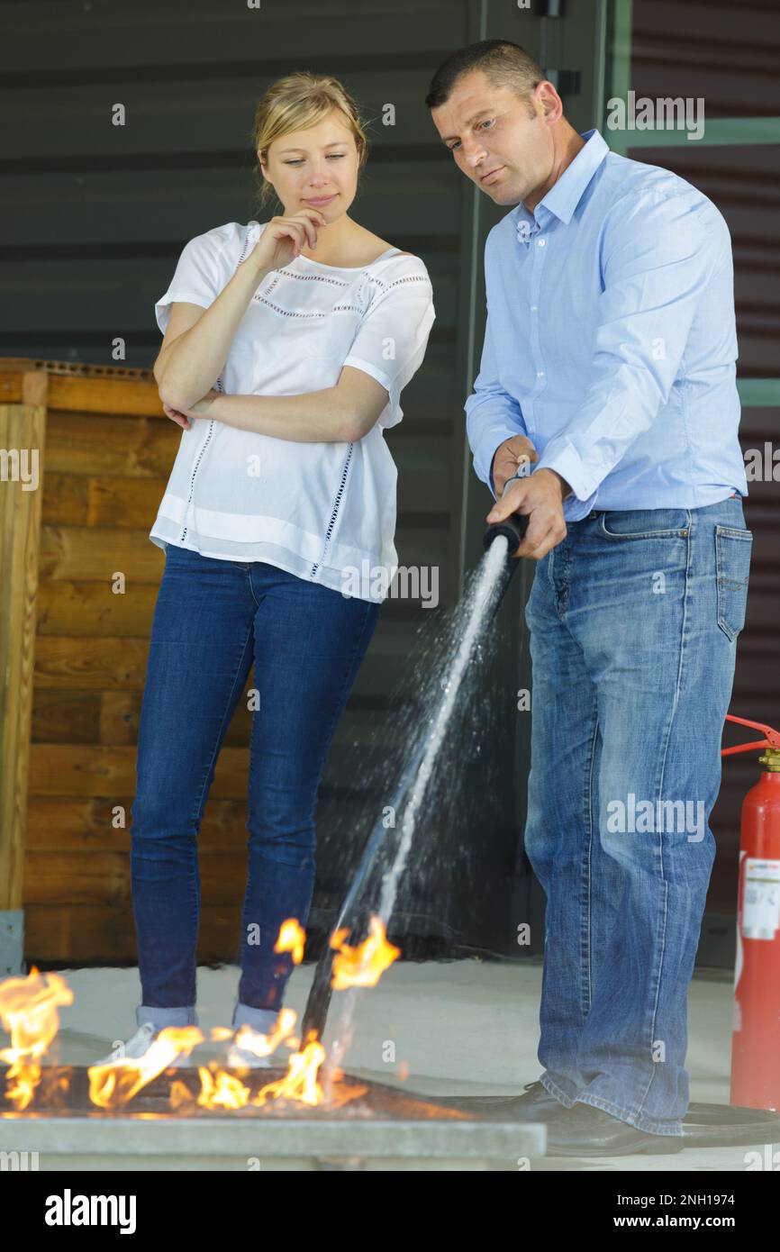 man and woman during fire safety training Stock Photo - Alamy