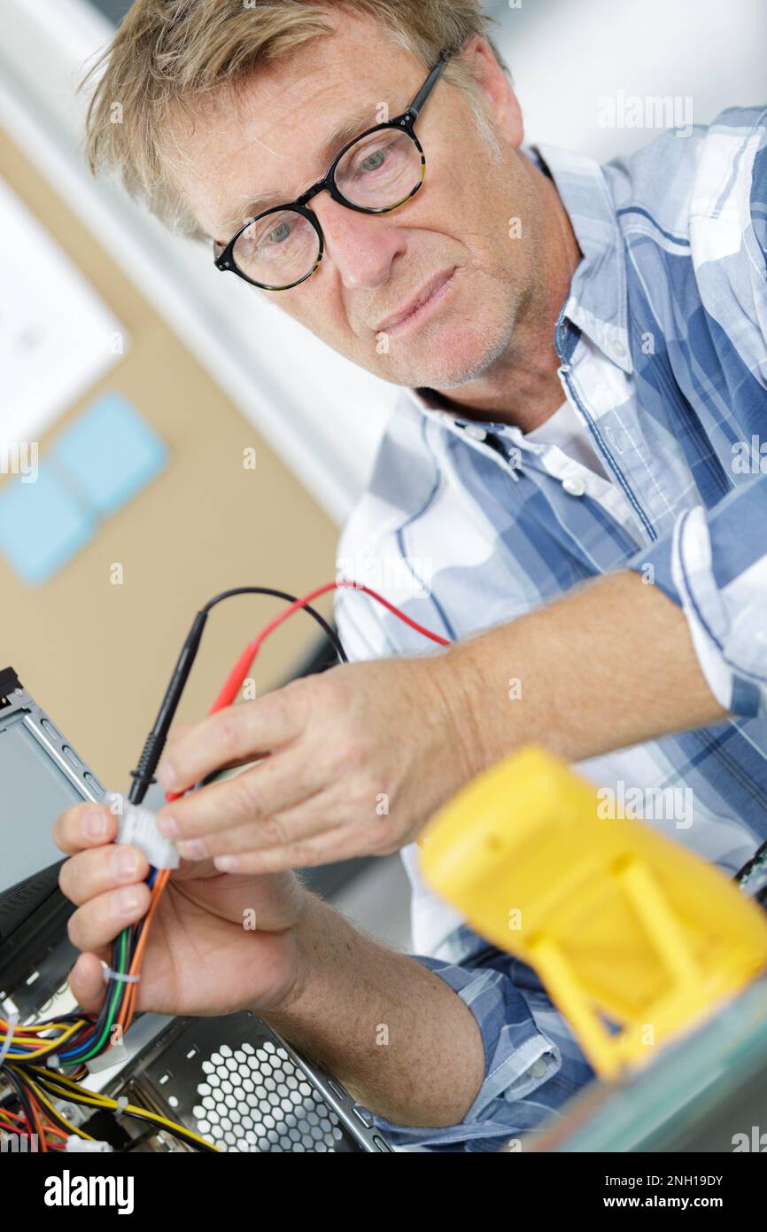 close-up of man measuring pc voltage with digital multimeter Stock ...