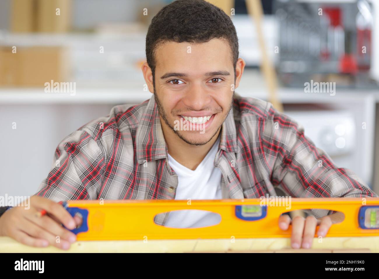Young man using spirit level hi-res stock photography and images - Alamy