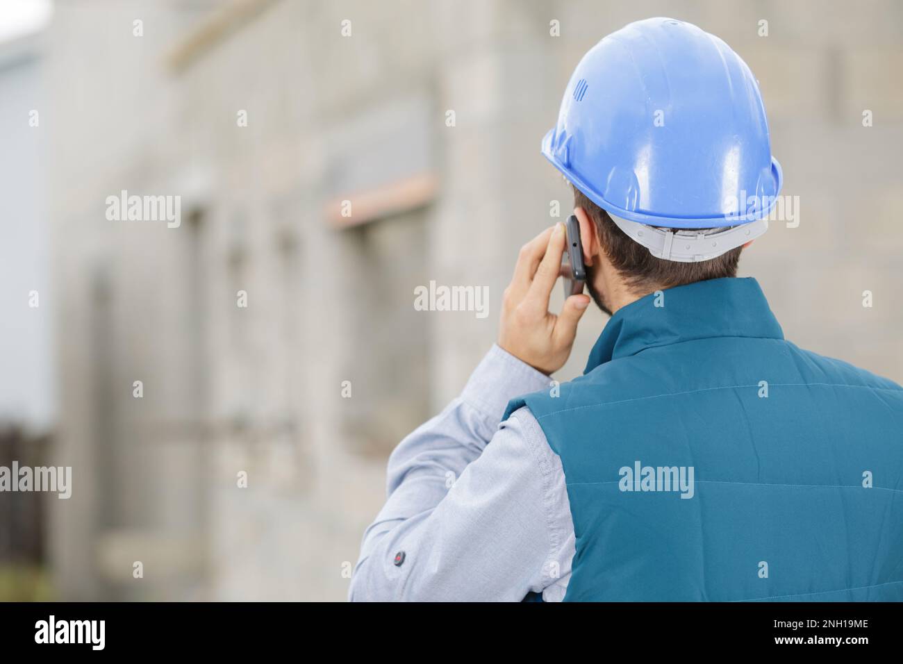 Construction texting on mobile phone hi-res stock photography and ...