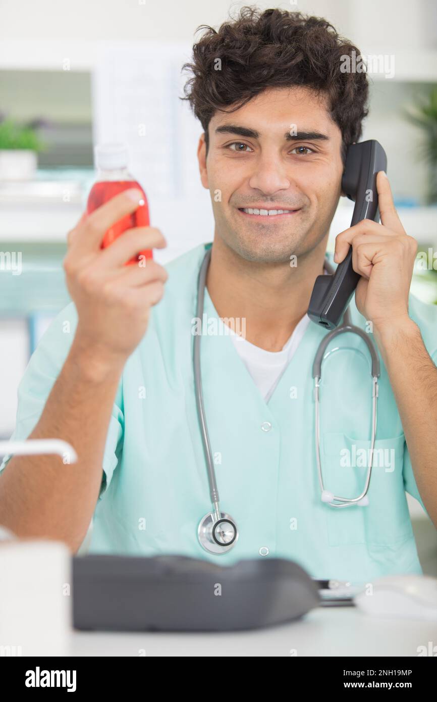 medical doctor talking on the phone at his workplace Stock Photo - Alamy
