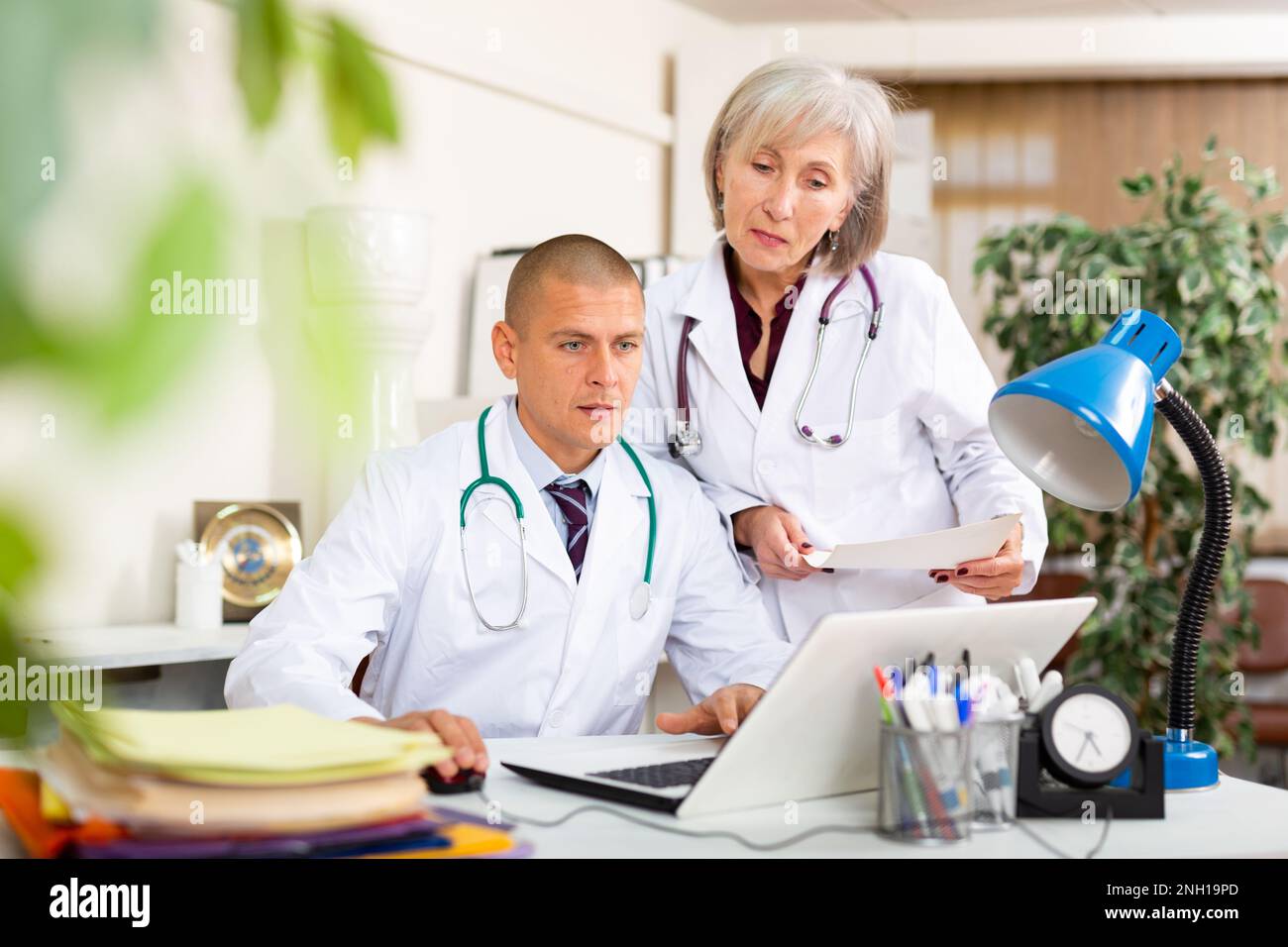 Two doctors in office at work Stock Photo - Alamy