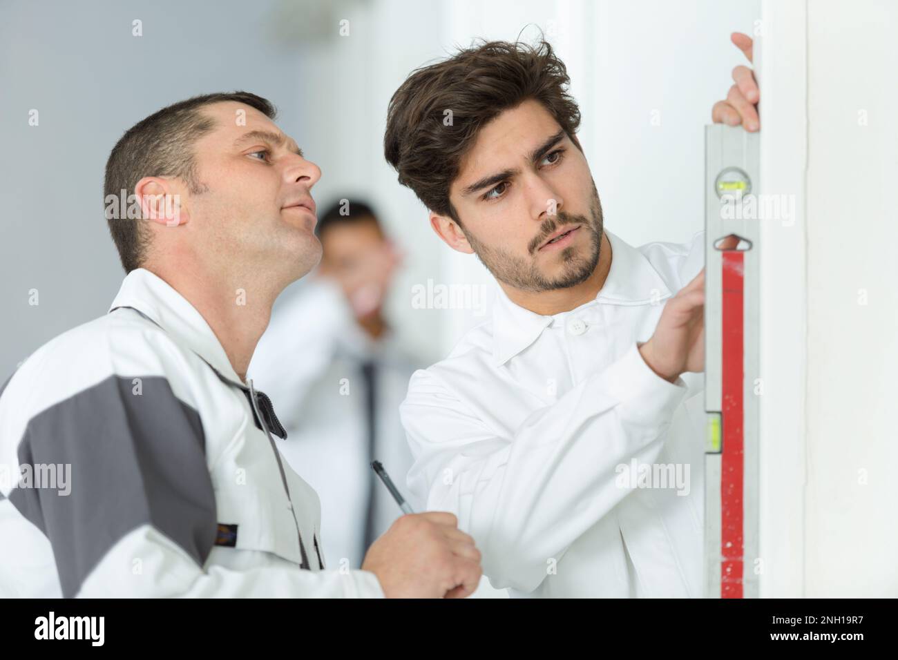 construction worker checking the spirit level Stock Photo - Alamy
