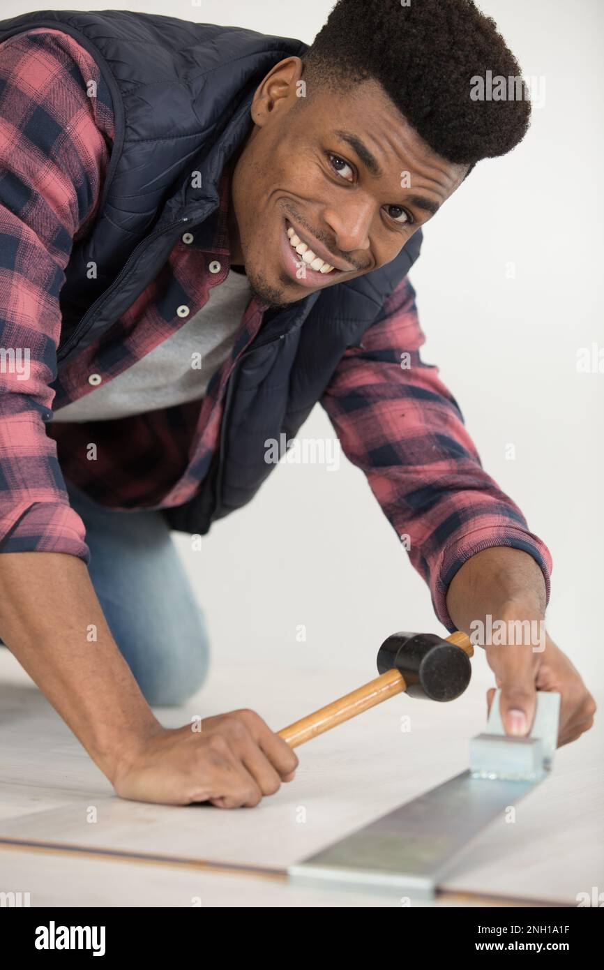 young positive builder finishing work Stock Photo - Alamy