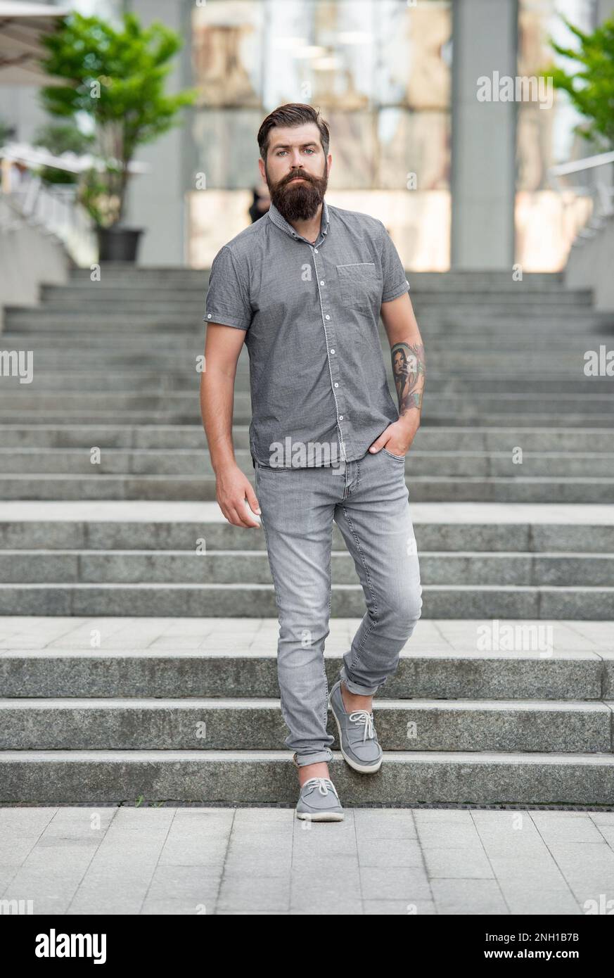 bearded guy walk downstairs. full length of guy with beard. hipster guy ...