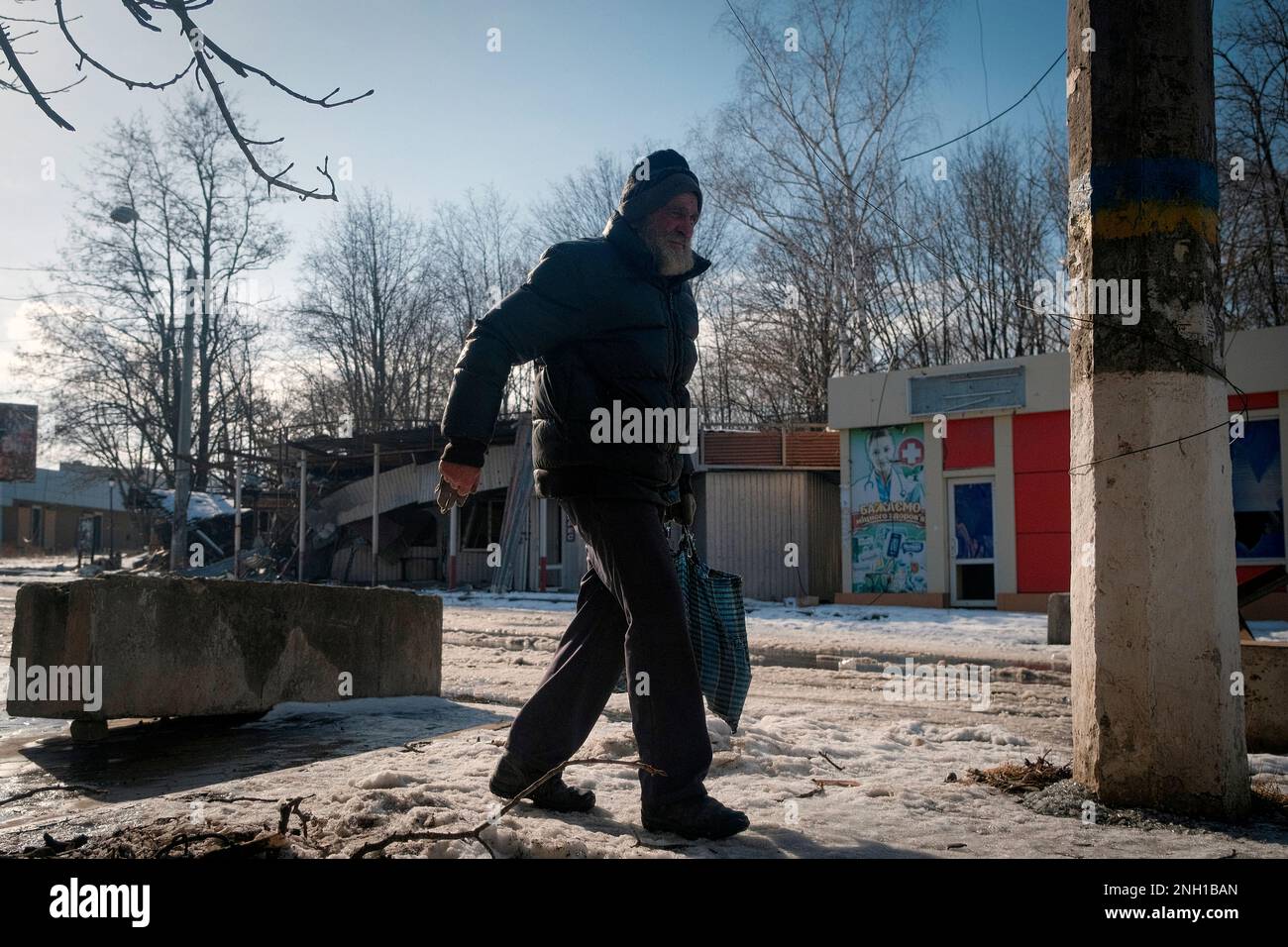 A local resident walks along a street in Bakhmut, Ukraine, Sunday, Feb ...