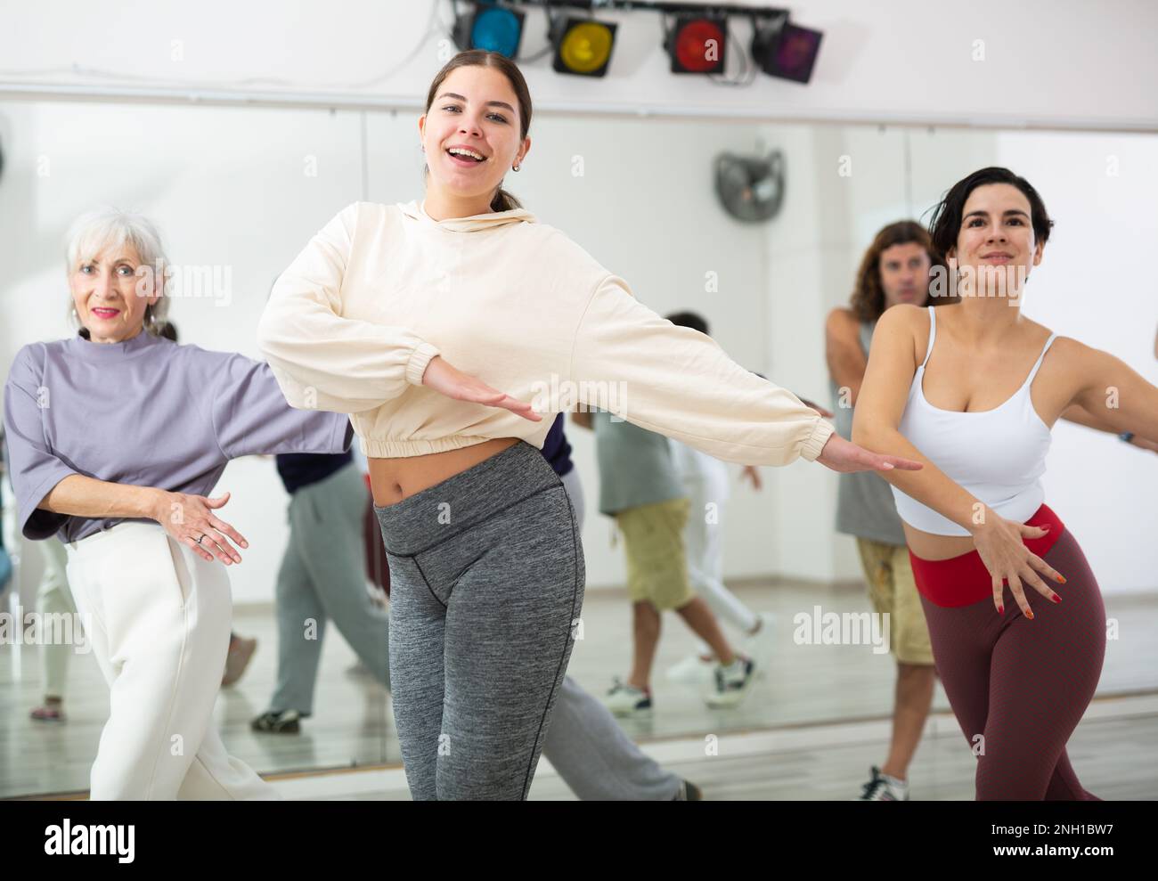Young girl practicing vigorous dance movements in group class Stock ...