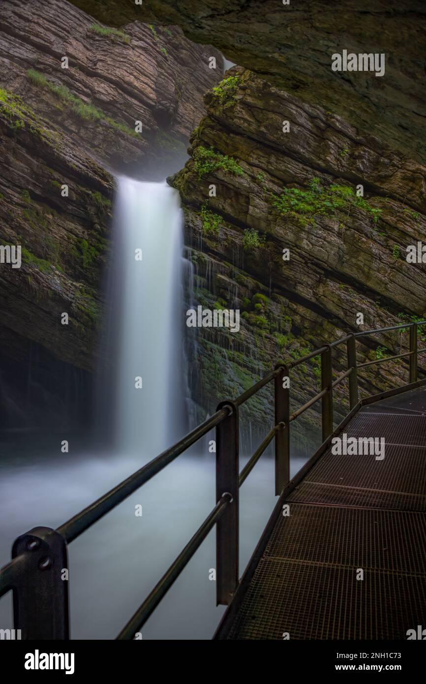 A mystical waterfall flowing from a cave Stock Photo - Alamy