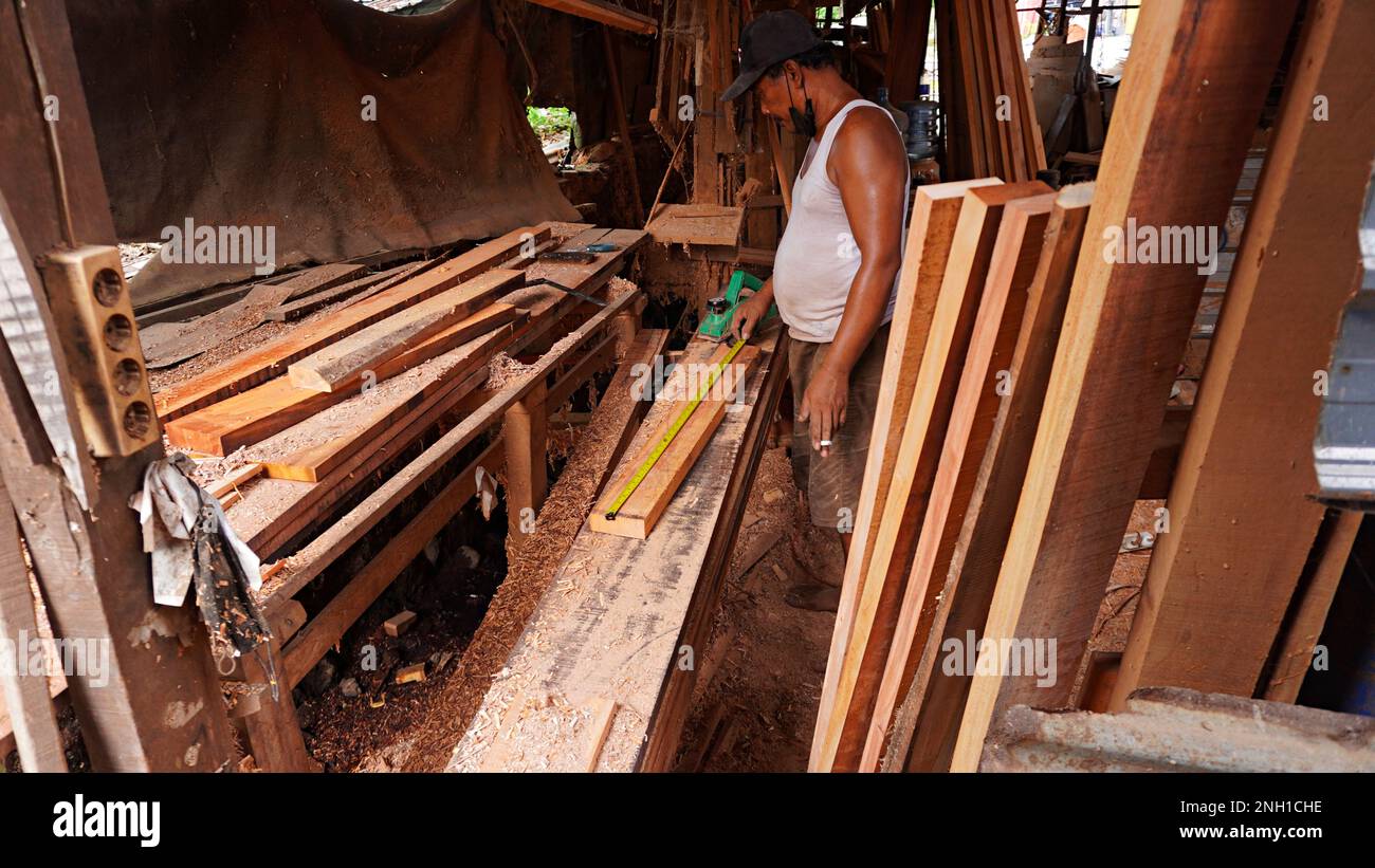 furniture carpenters are smoothing wood blocks using a machine to make ...