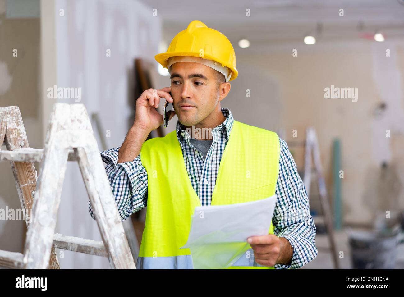 Man builder having telephone conversation in construction site Stock ...