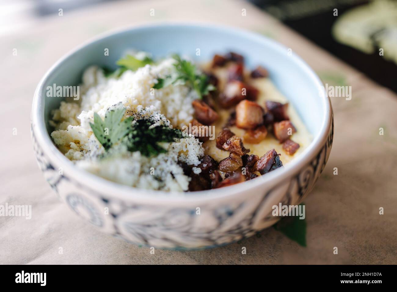 Traditional Ukrainian dish Banosh. Corn porridge in butter sprinkled on ...