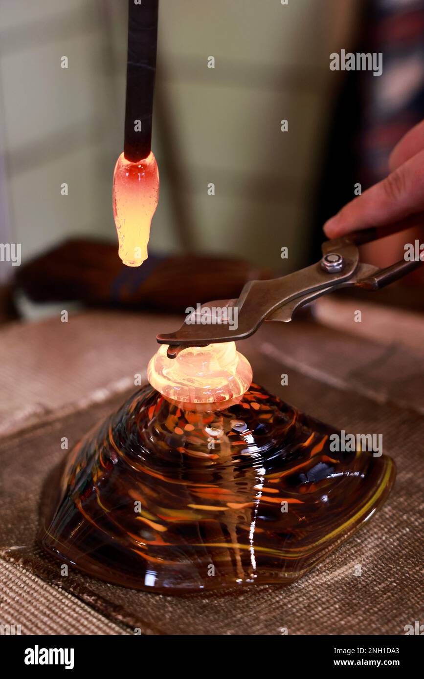 Glassblower crafting intricate glass object Stock Photo - Alamy