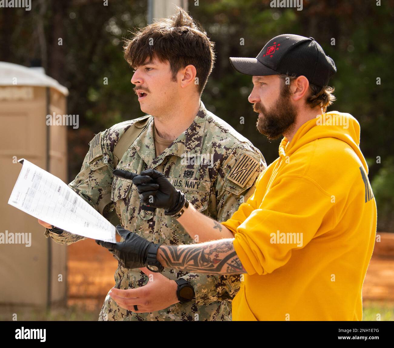 A Navy Explosive Ordnance Disposal School Sailor talks with a local ...