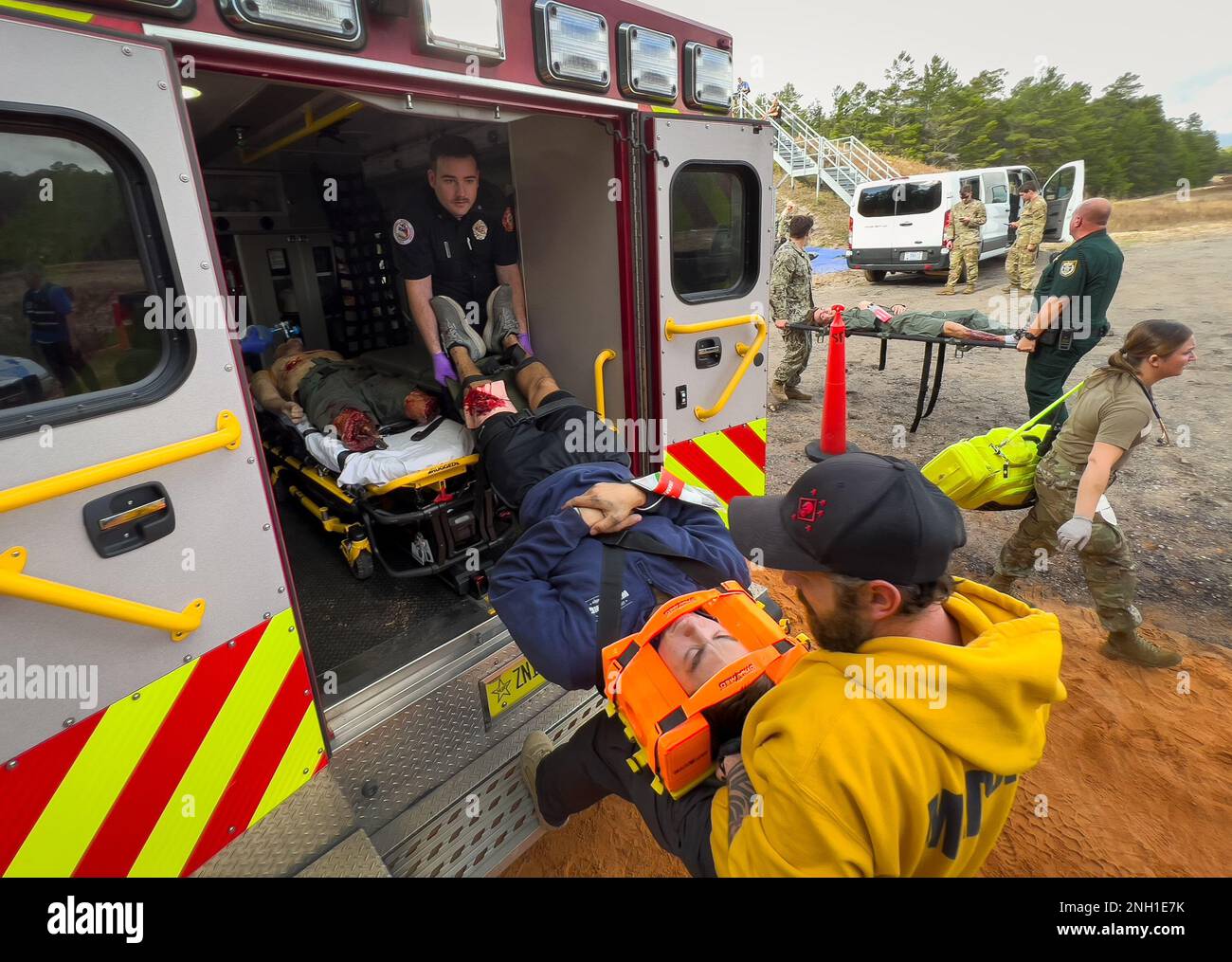 Local county medics lift a simulated victim into an ambulance during an ...