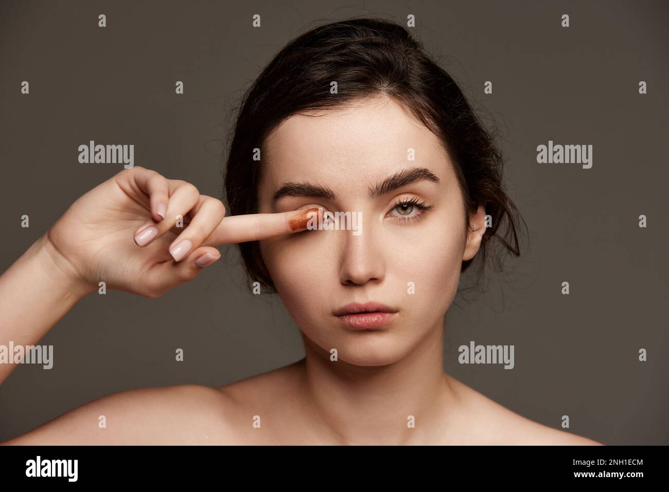 Makeup artist. Portrait of young beautiful girl with brown hair posing ...