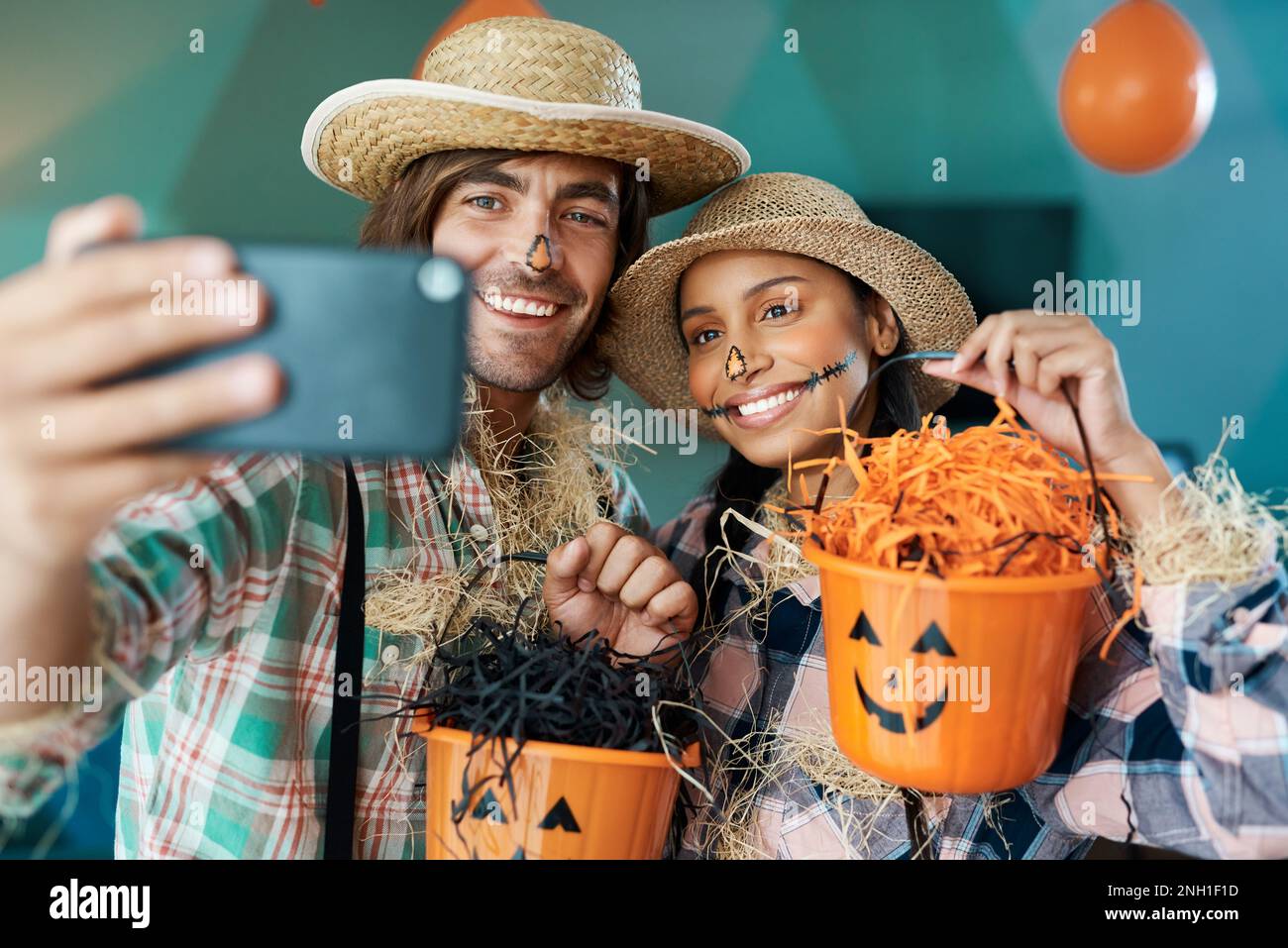 Were creeping it real. a young couple taking selfies while holding ...