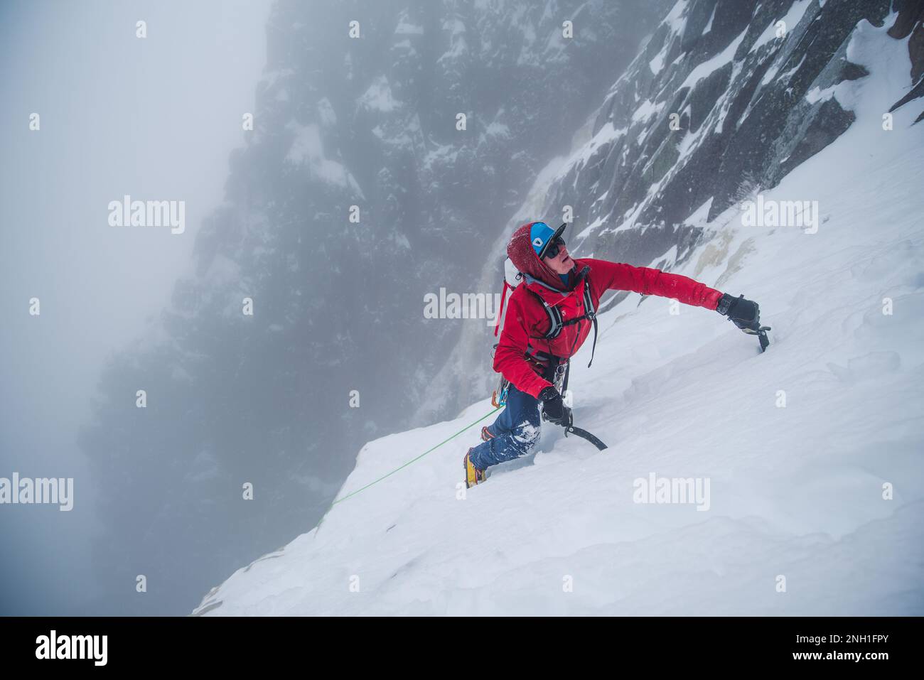 Ice climber climbing steep ice wall in winter Stock Photo - Alamy