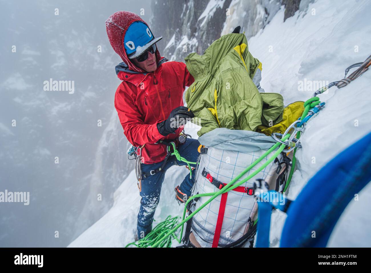 Young man putting on jacket hi-res stock photography and images - Alamy