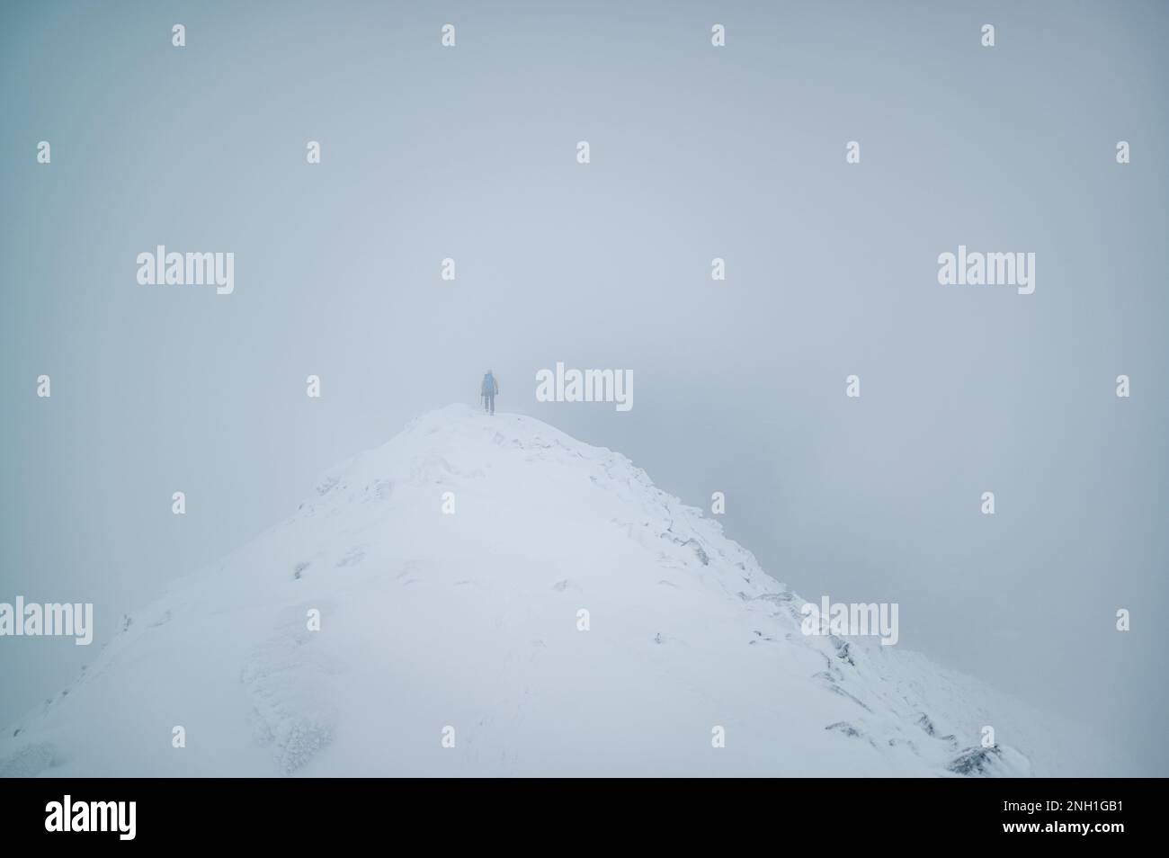 Ice climbers climbing a frozen alpine ridge on a mountain Stock Photo ...