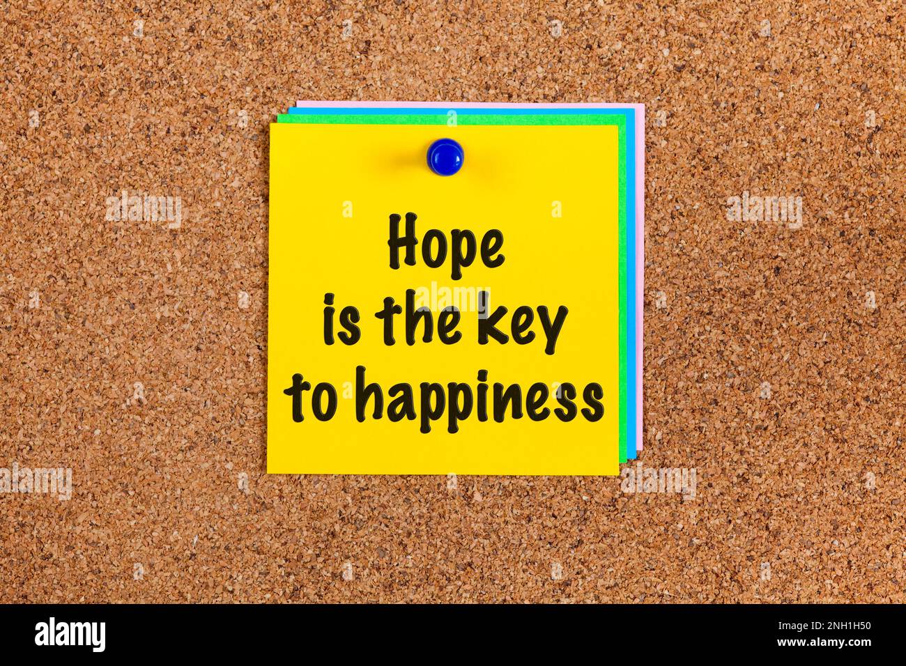 A Yellow paper note with words Hope is the Key to Happiness on a ...